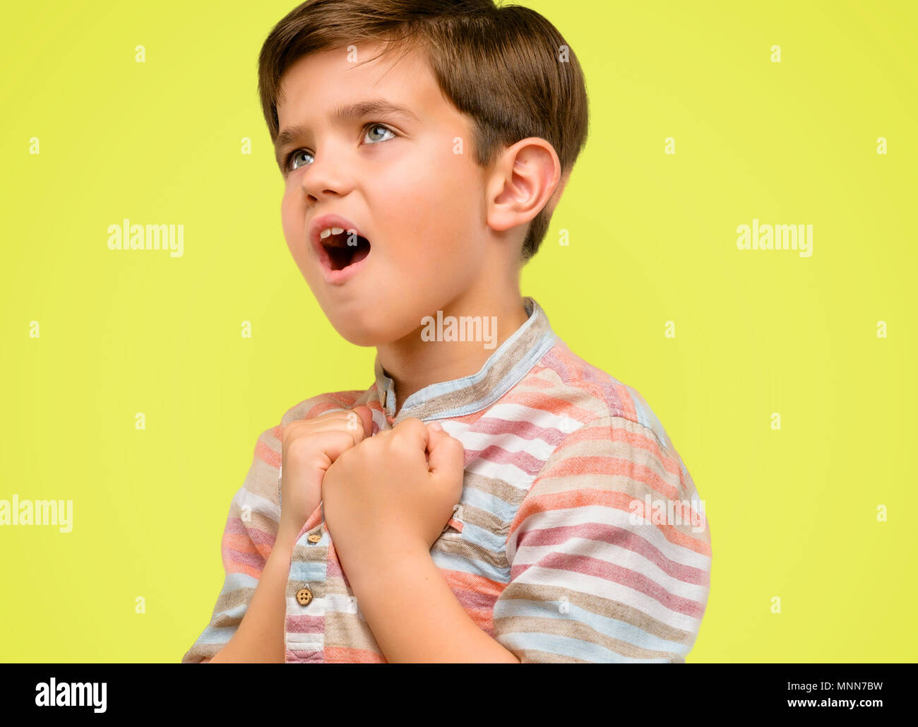 Handsome toddler child with green eyes happy and excited celebrating ...