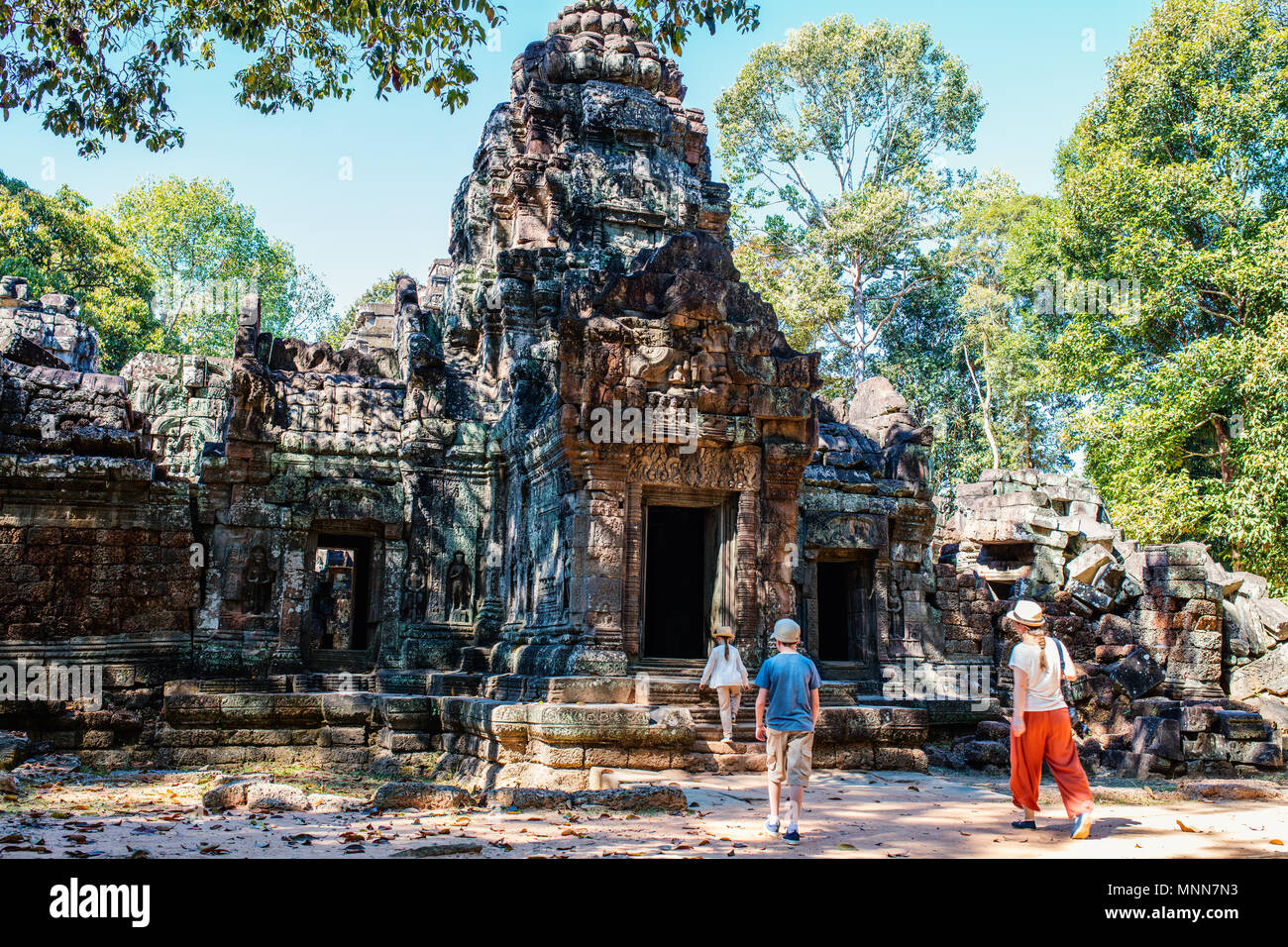 Family visiting ancient Ta Som temple in Angkor Archaeological area in ...