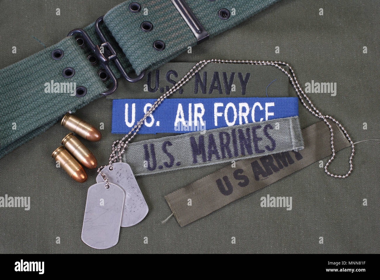 US military concept on olive green uniform background Stock Photo - Alamy