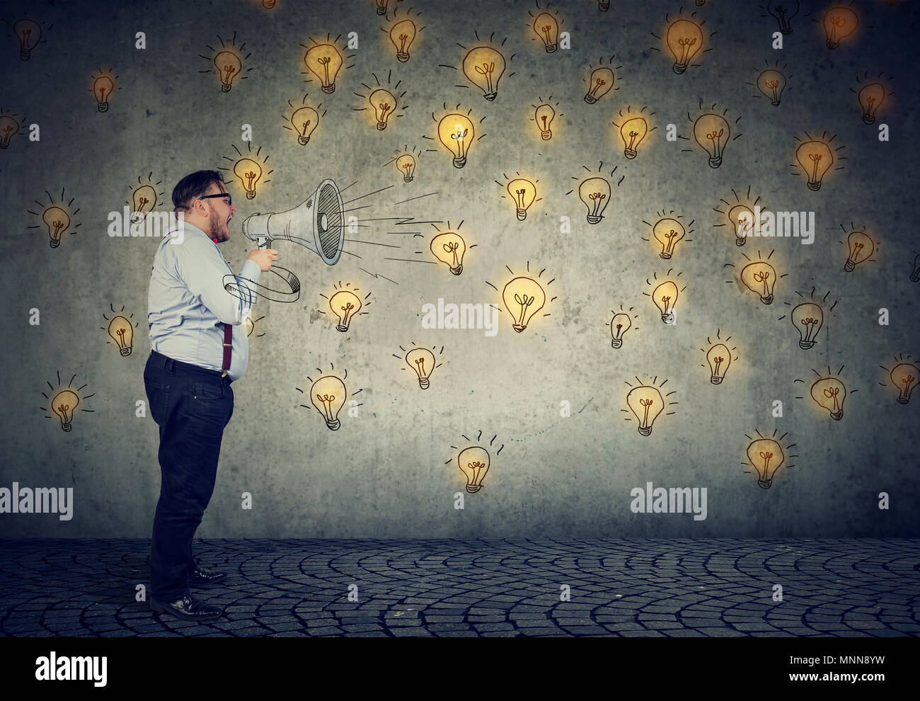 Man screaming out his ideas loud in megaphone spreading his ideas ...