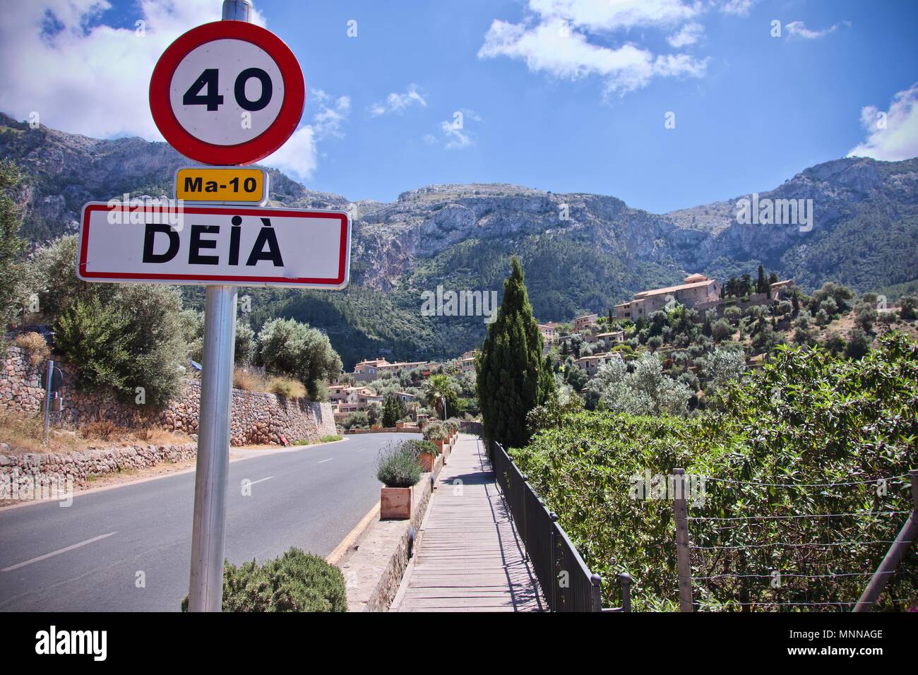 view of Deia with a road and speed limit sign Stock Photo - Alamy