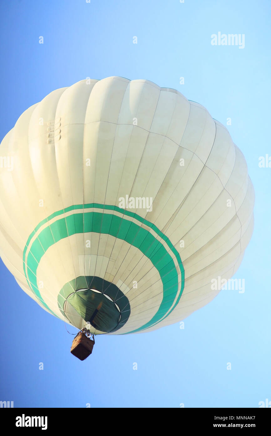 Hot air balloon with green stripes, blue sky Stock Photo - Alamy