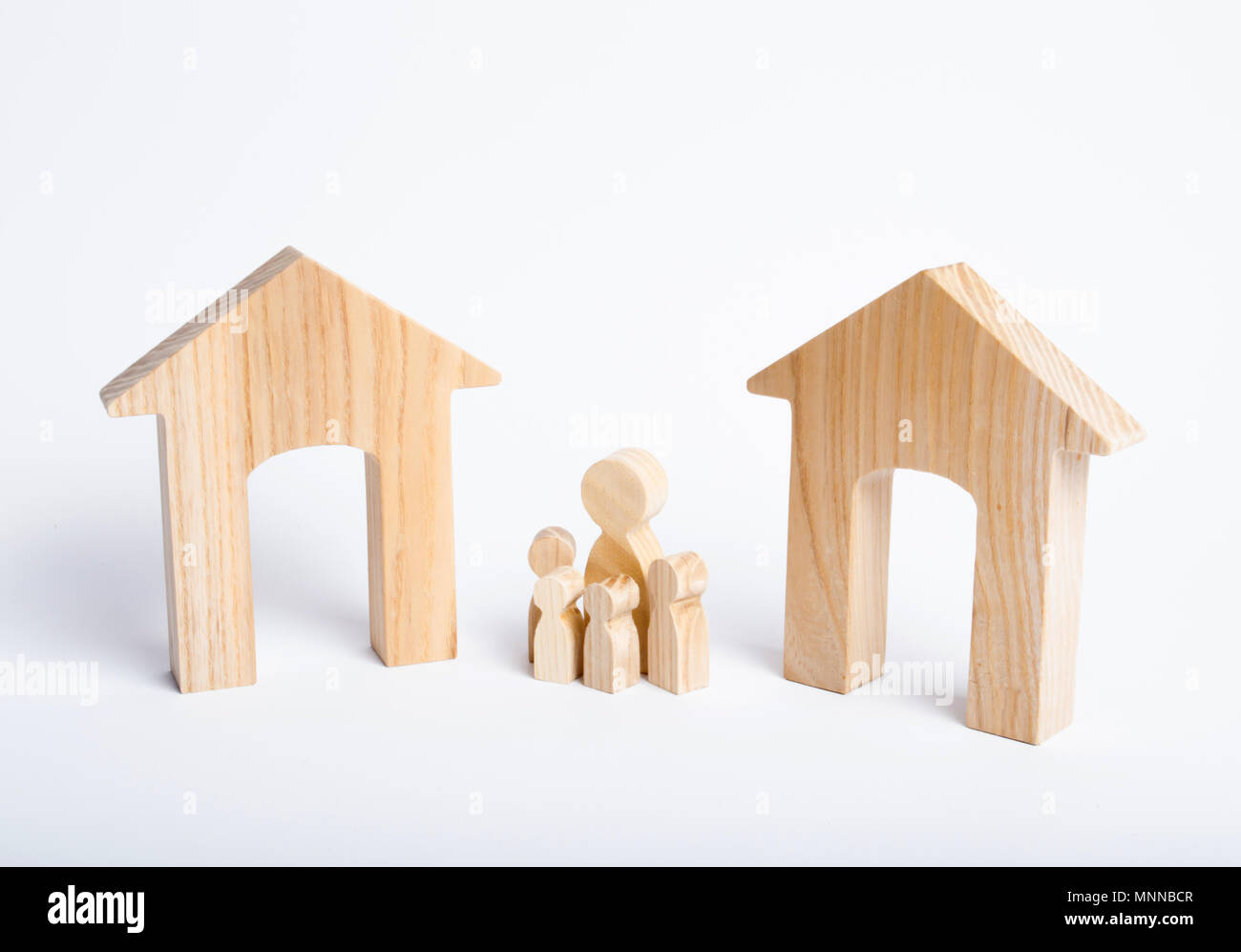 A family with children stand between two houses and make a decision ...