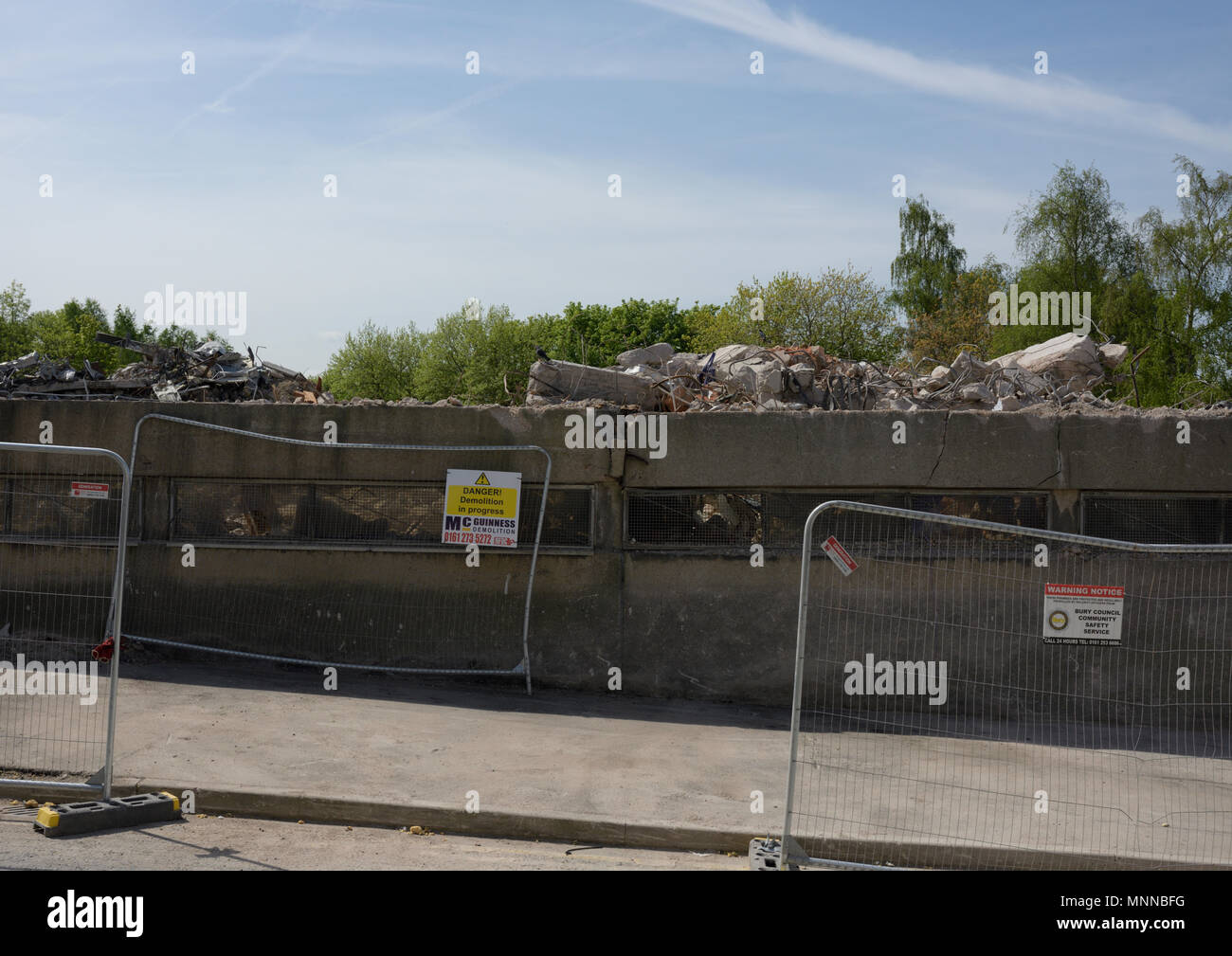 Steel security fencing with missing section in front of demolition site ...