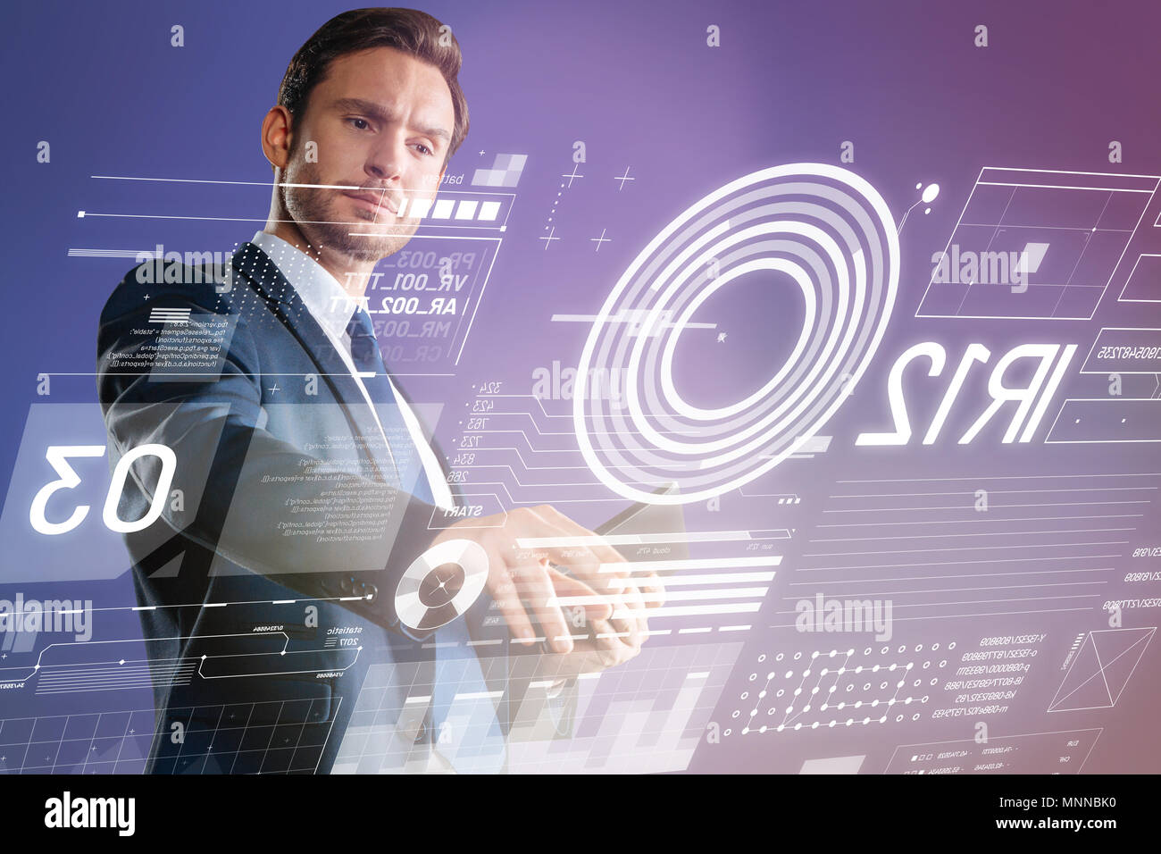 Clever programmer touching the screen and looking interested Stock Photo - Alamy