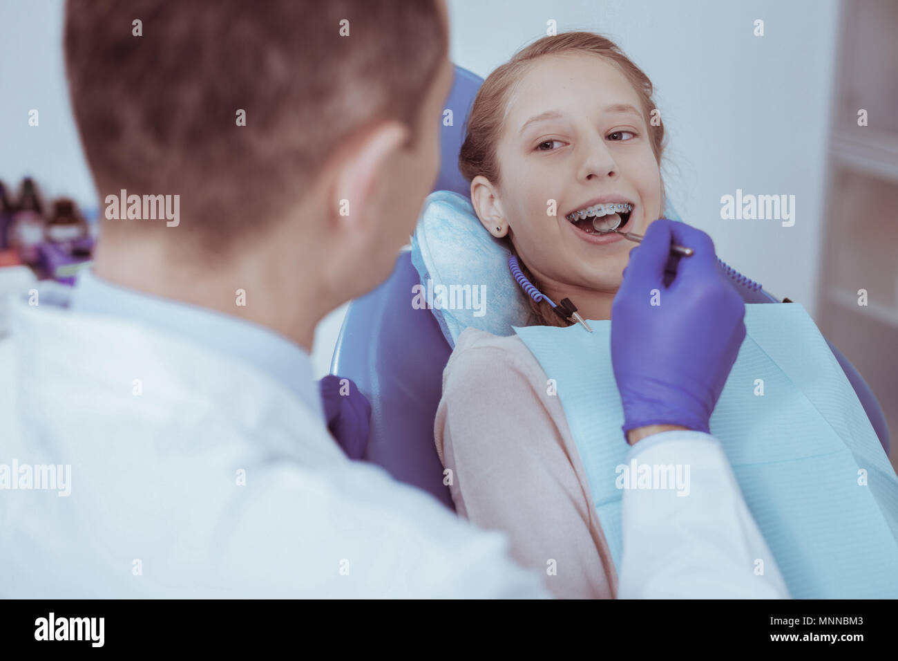 Professional male dentist examining teeth Stock Photo - Alamy