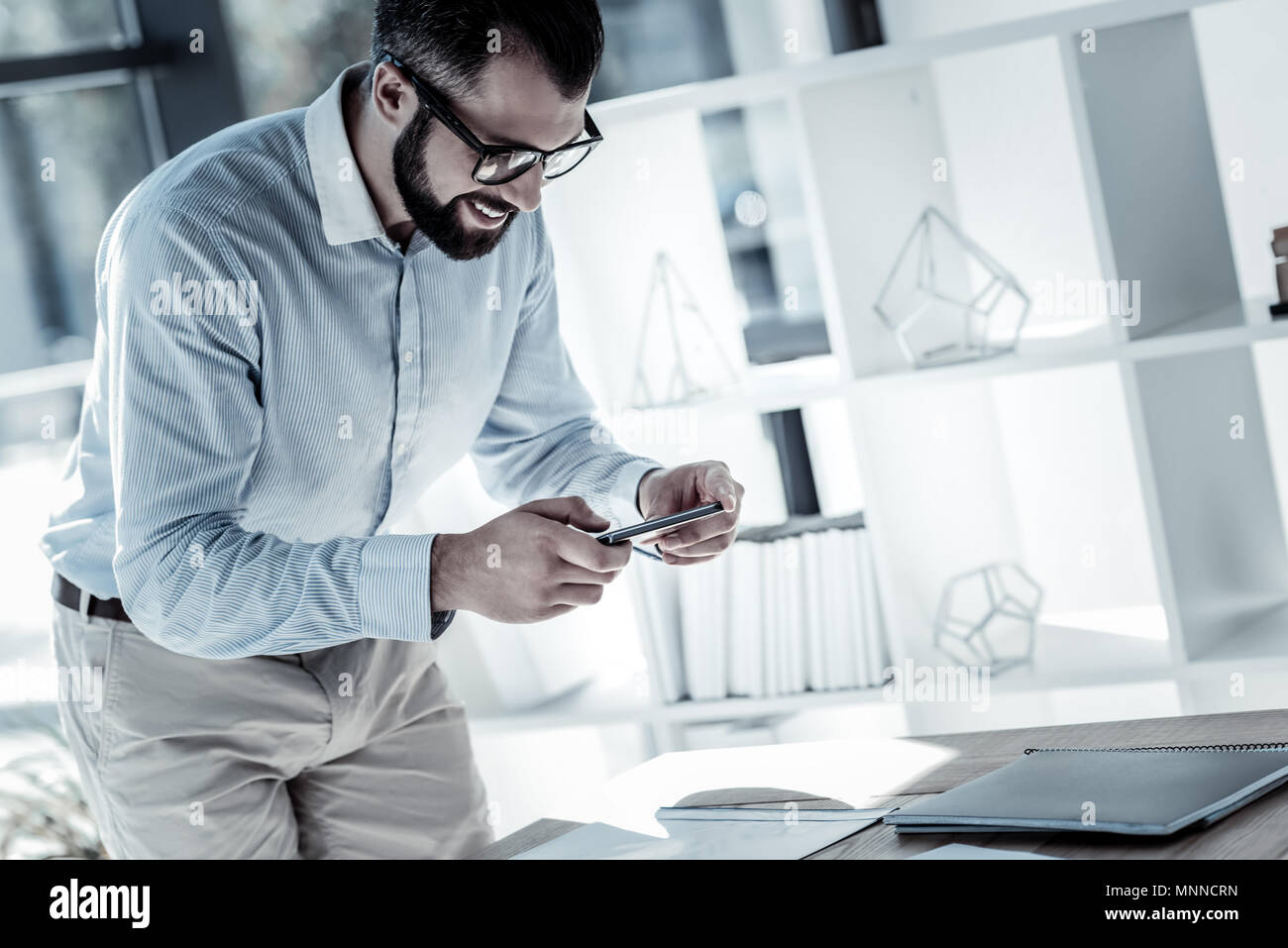 Satisfied busy man standing and making photo Stock Photo - Alamy