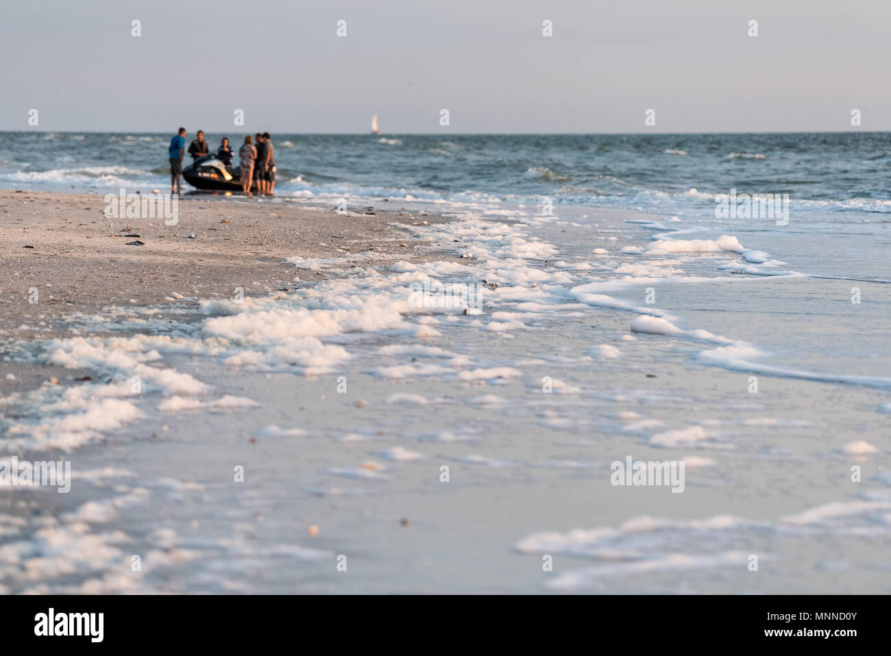Naples, USA - April 29, 2018: Closeup of lots of foam on coast during ...