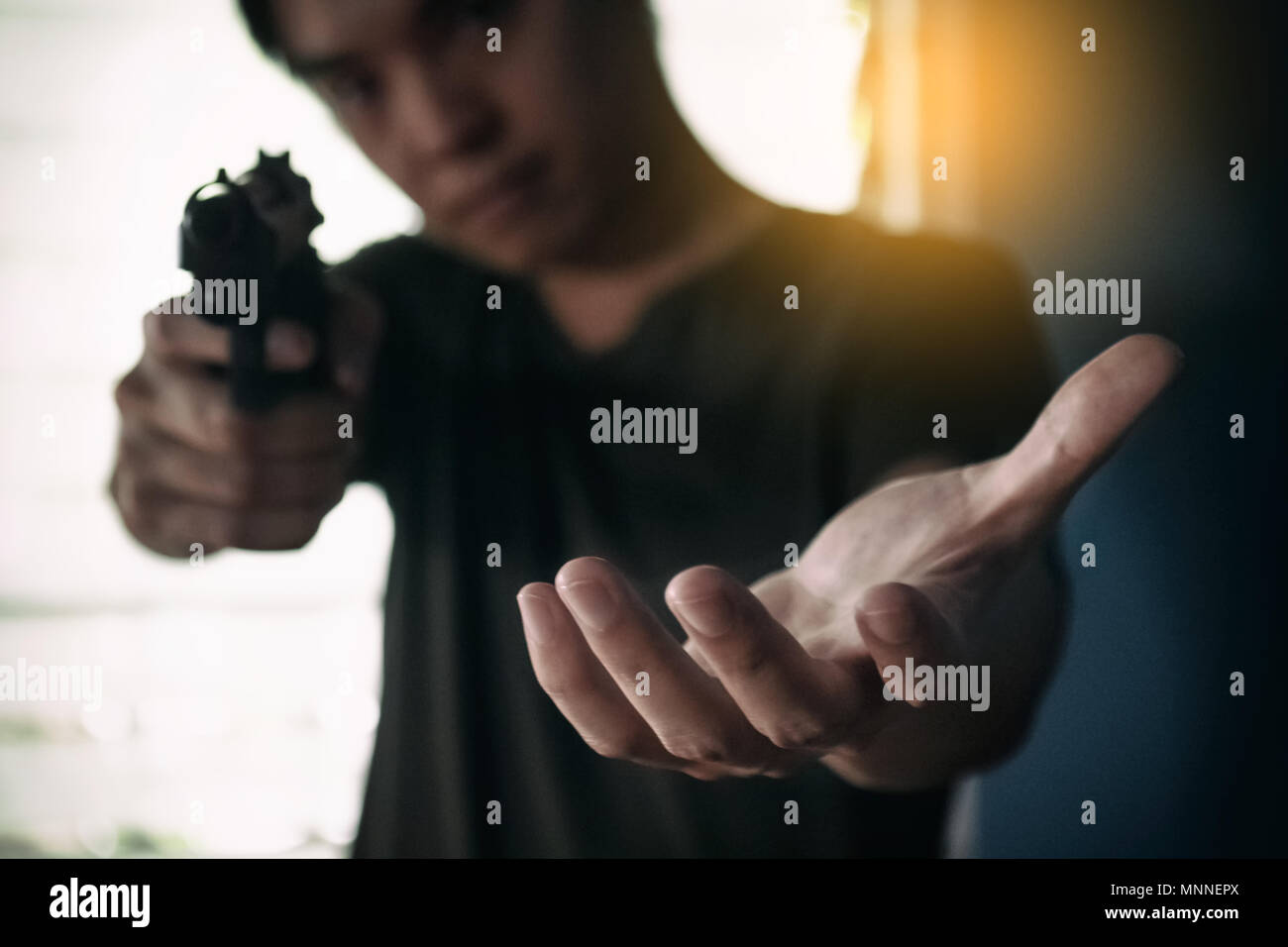 Gangster or thief hold the gun in hand weapon for steal wallet Stock ...