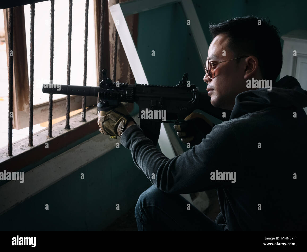 Man aiming the gun to an invisible target with a sniper , selective ...