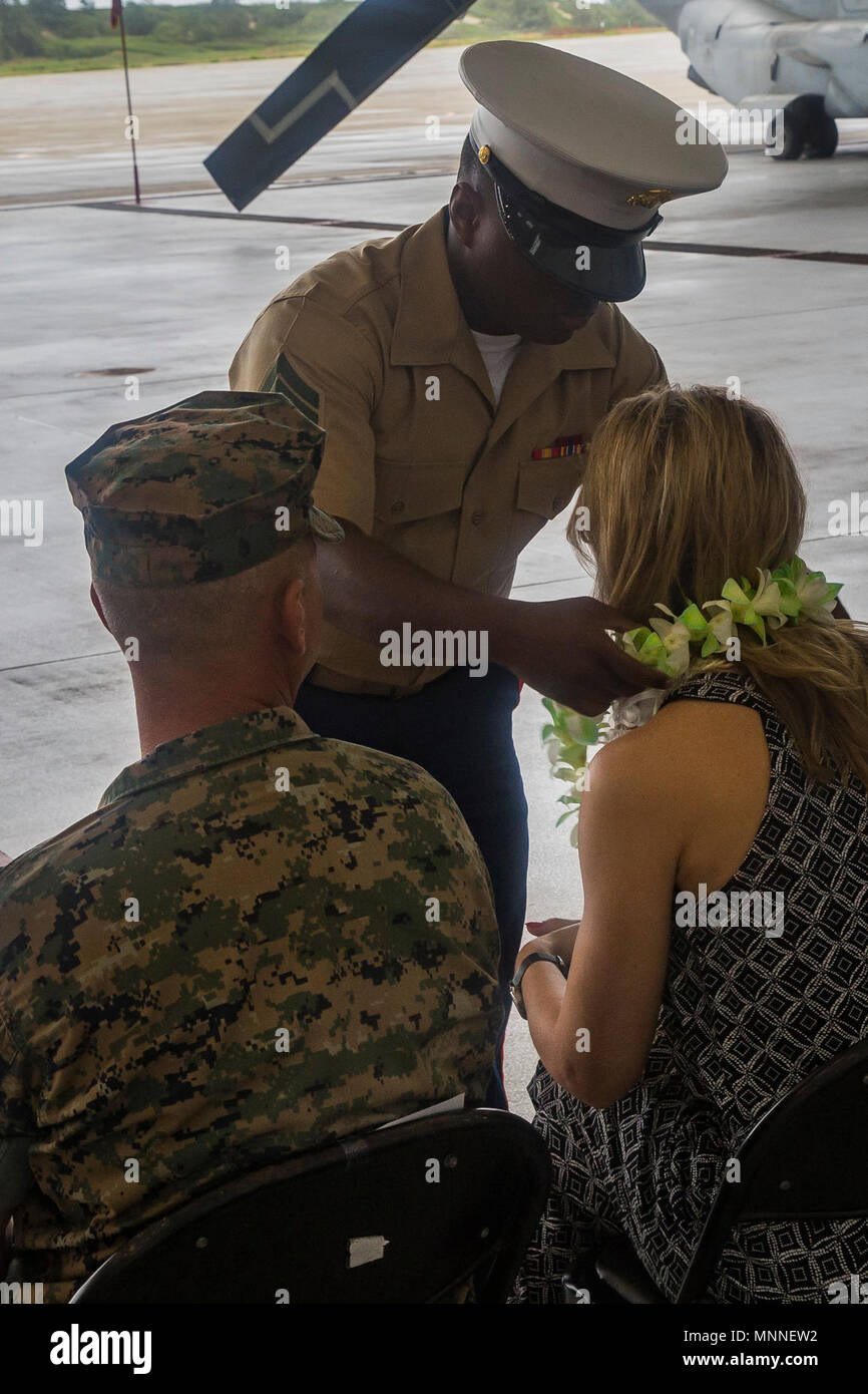 A U.S. Marine presents the wife of Sgt.Maj. Douglas Hester, off-going ...
