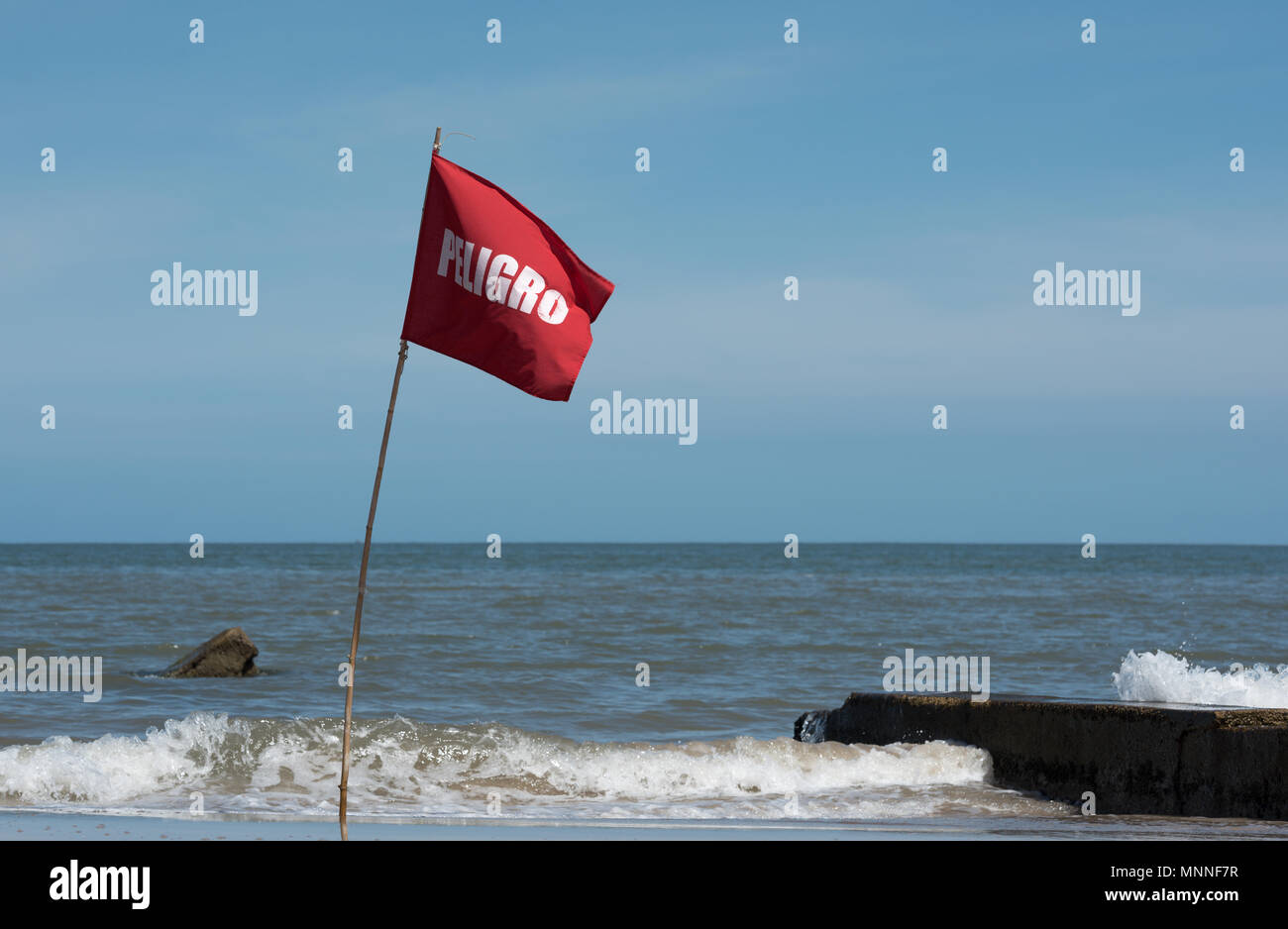 Danger flag in spanish Stock Photo - Alamy