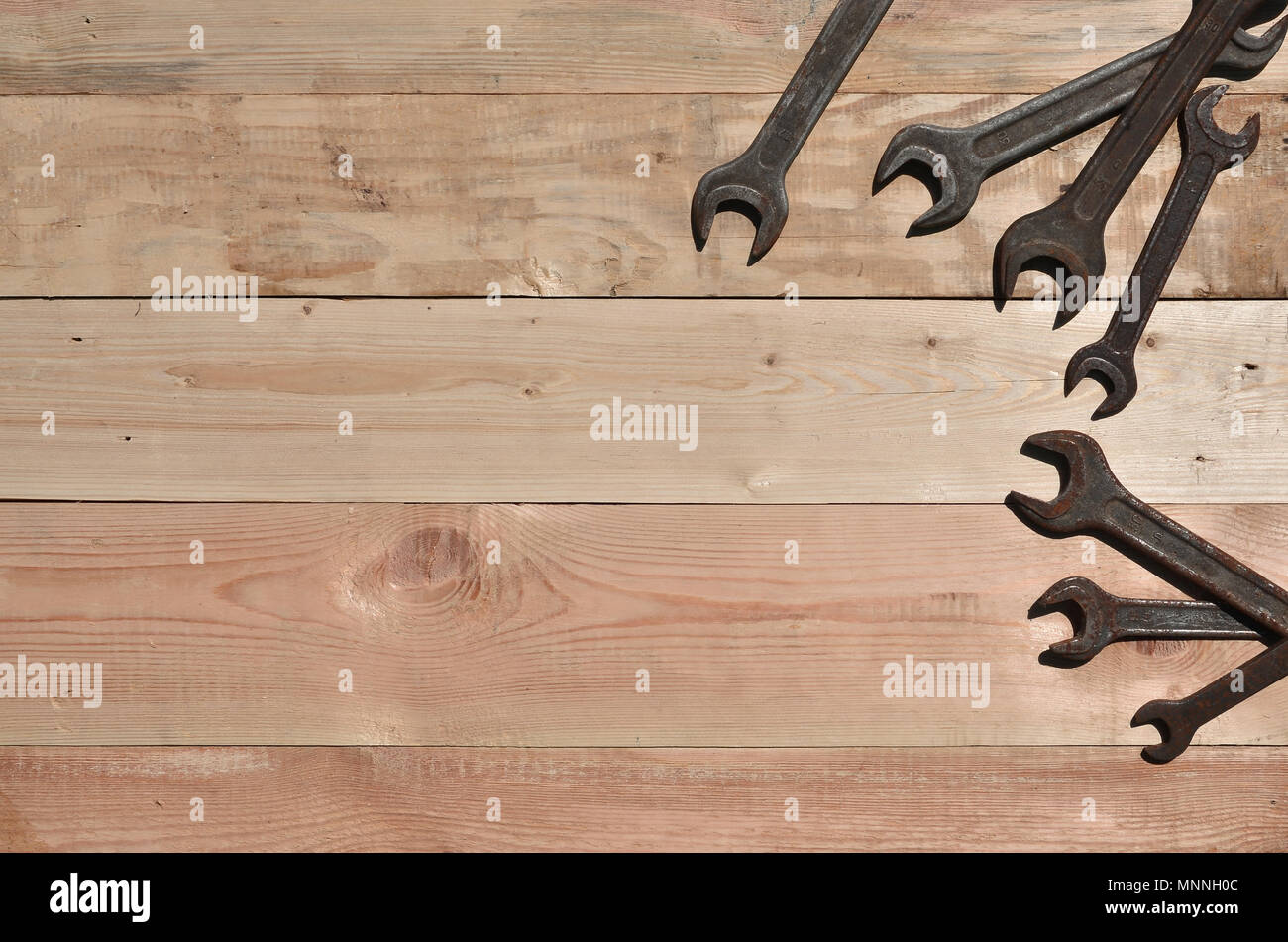 A few rusty spanners on a wooden background. Obsolete household tools ...