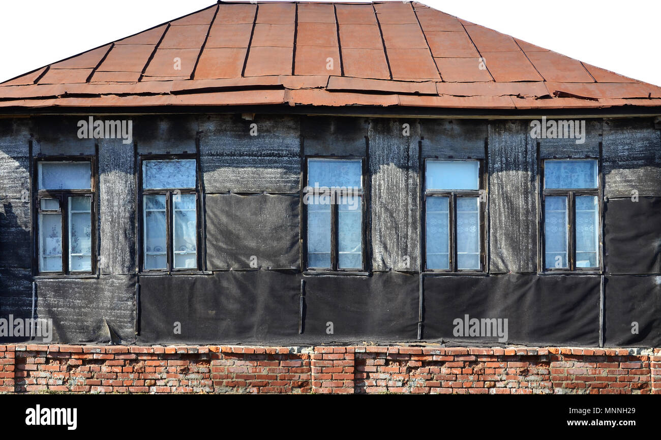 The texture of a brick wall with a few windows. Glazed windows in the ...