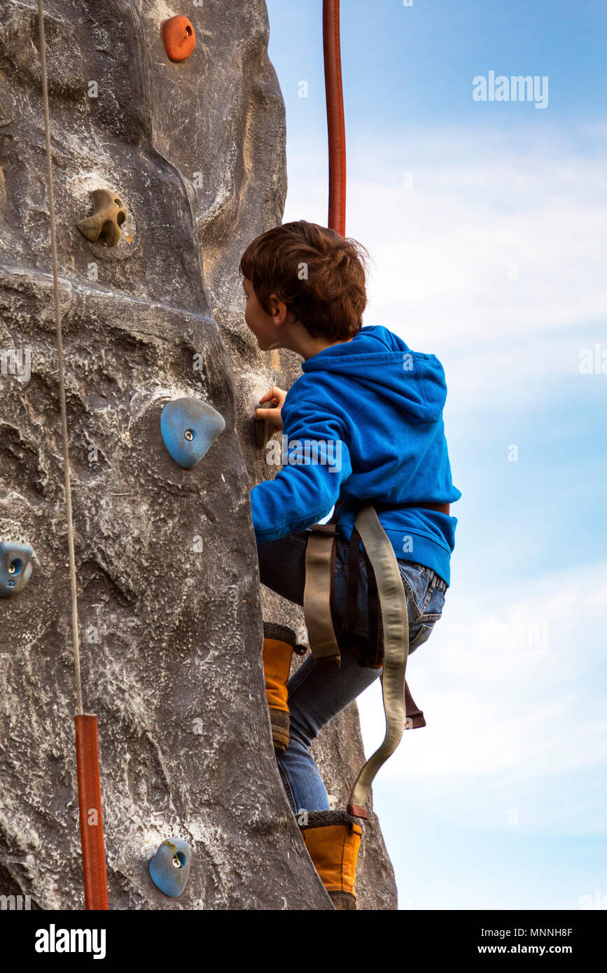 Child at rock climbing display at Stokesley Show, North Yorkshire ...