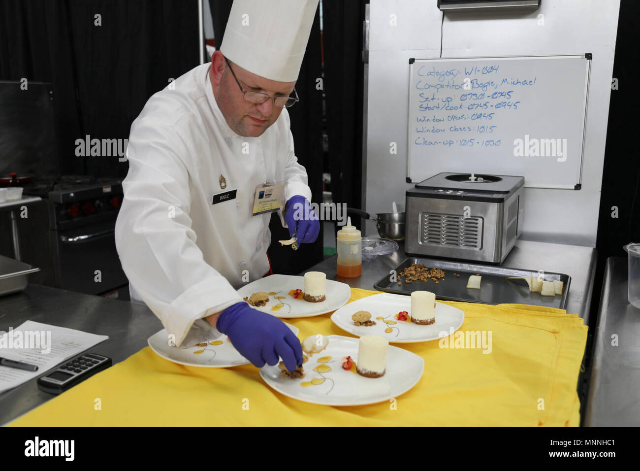 Sgt. 1st Class Michael Bogle adds ice cream quenelles to his plated ...
