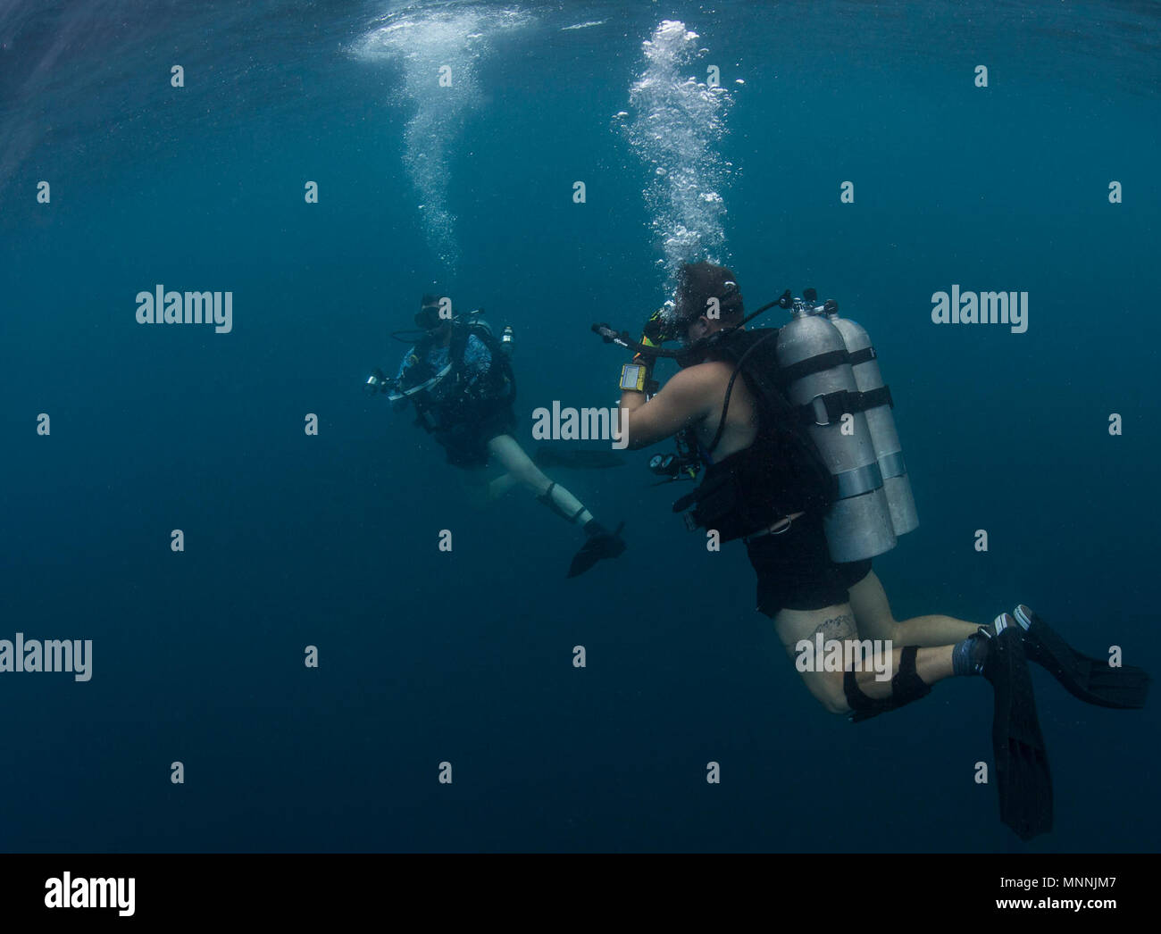 Navy Diver 3rd Class John Gerlicher, right, assigned to the Naval Base ...