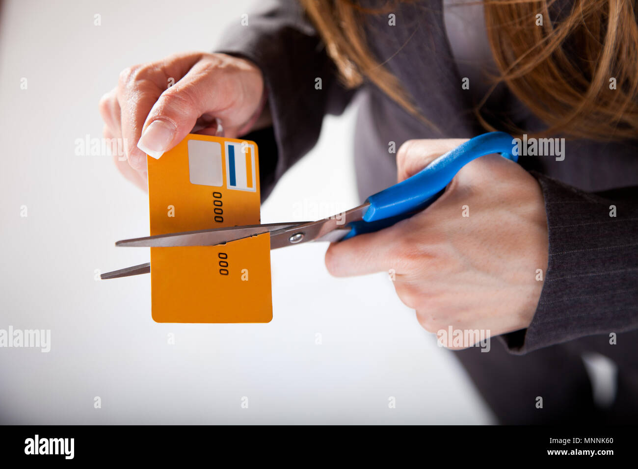 A female about cut up old credit card Stock Photo - Alamy