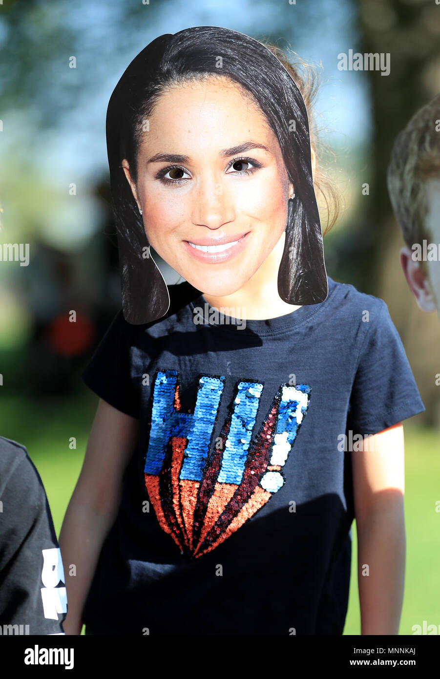 A Royal fan in a Meghan Markle face mask ahead of the wedding of Prince ...