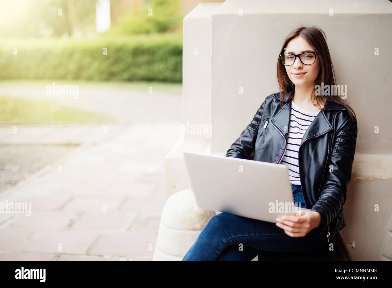 Young student on university campus with computer laptop Stock Photo - Alamy
