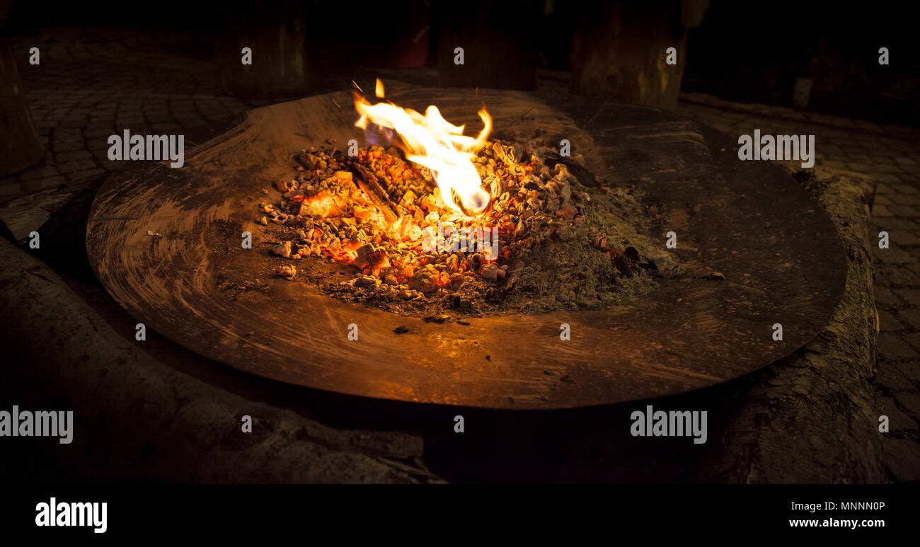 Fire in a big metal shell isolated on a black background Stock Photo ...