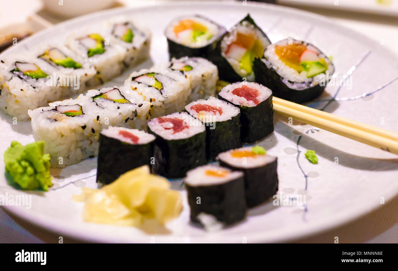 Japanese food: plate of sushi and maki with wasabi and chopsticks Stock ...