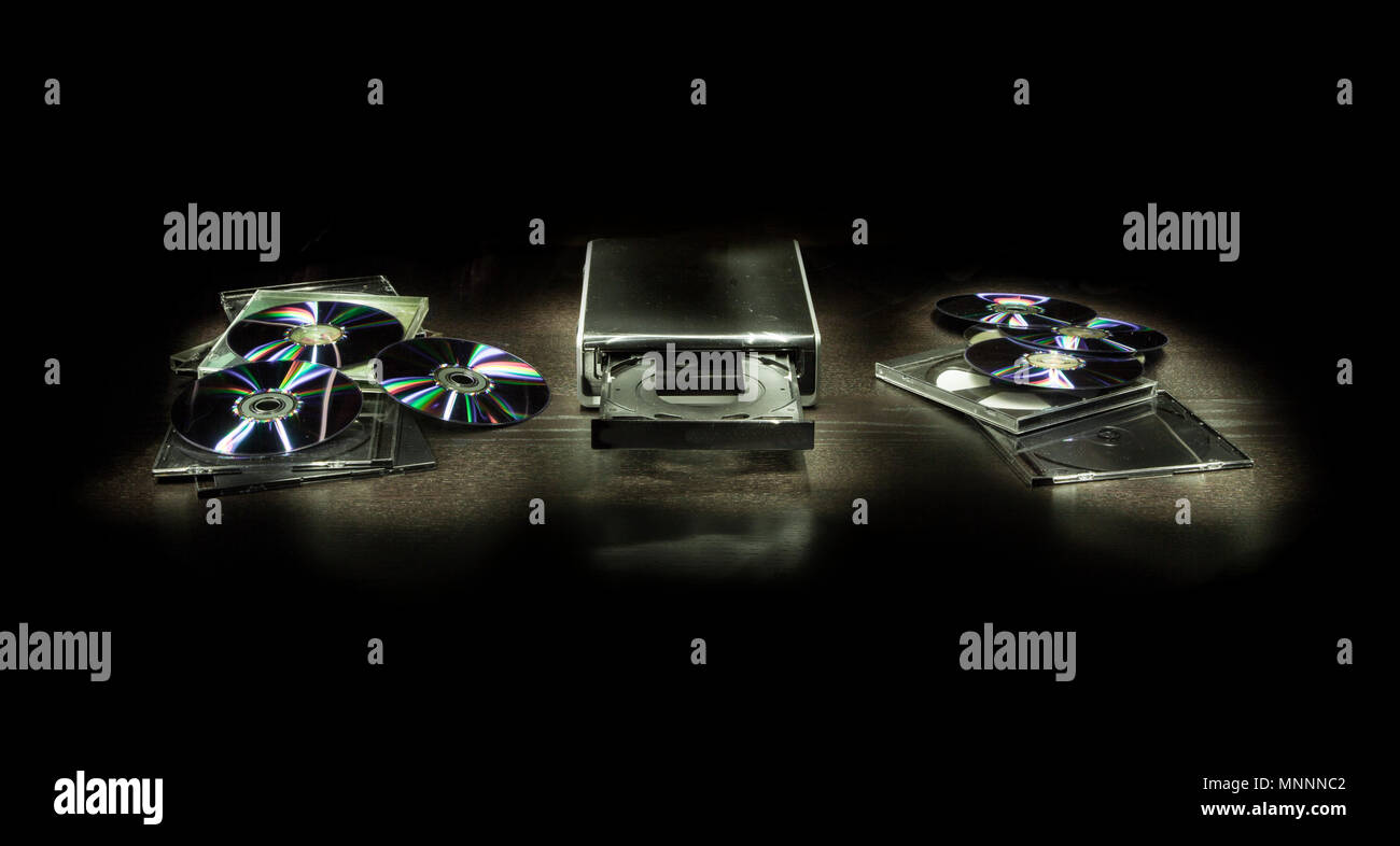 Composition: CDs, opened CD player and cases isolated on a black ...