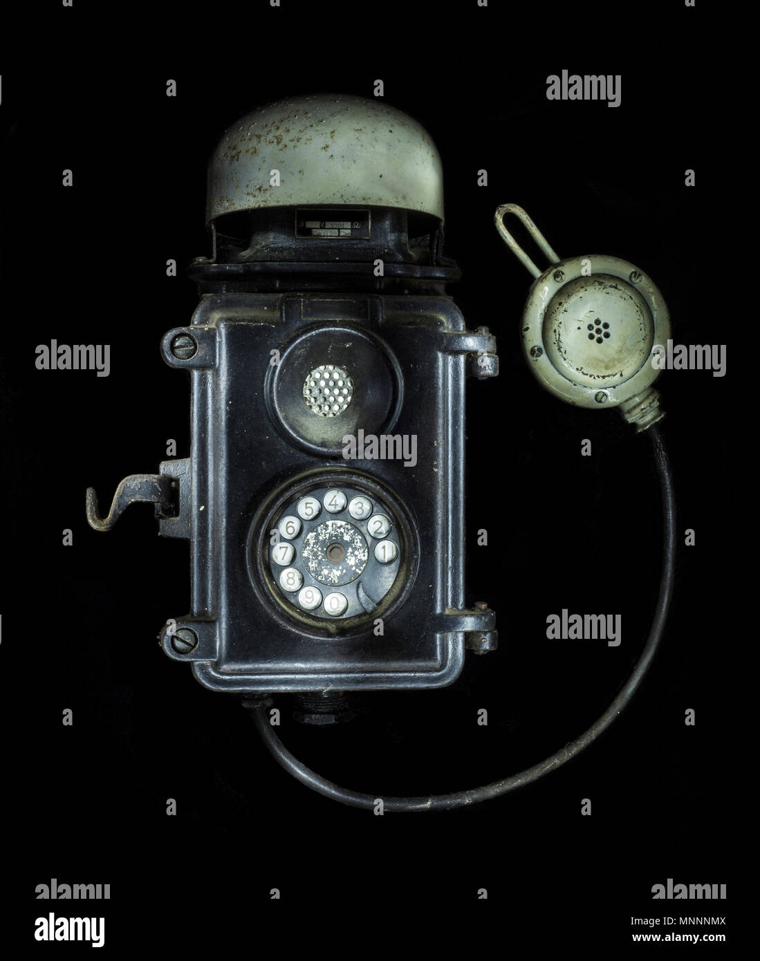 Old black telephone isolated on a black background Stock Photo - Alamy