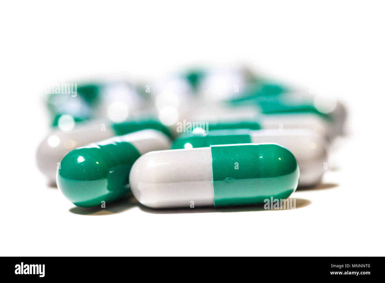 Green and grey capsules isolated on white background Stock Photo - Alamy