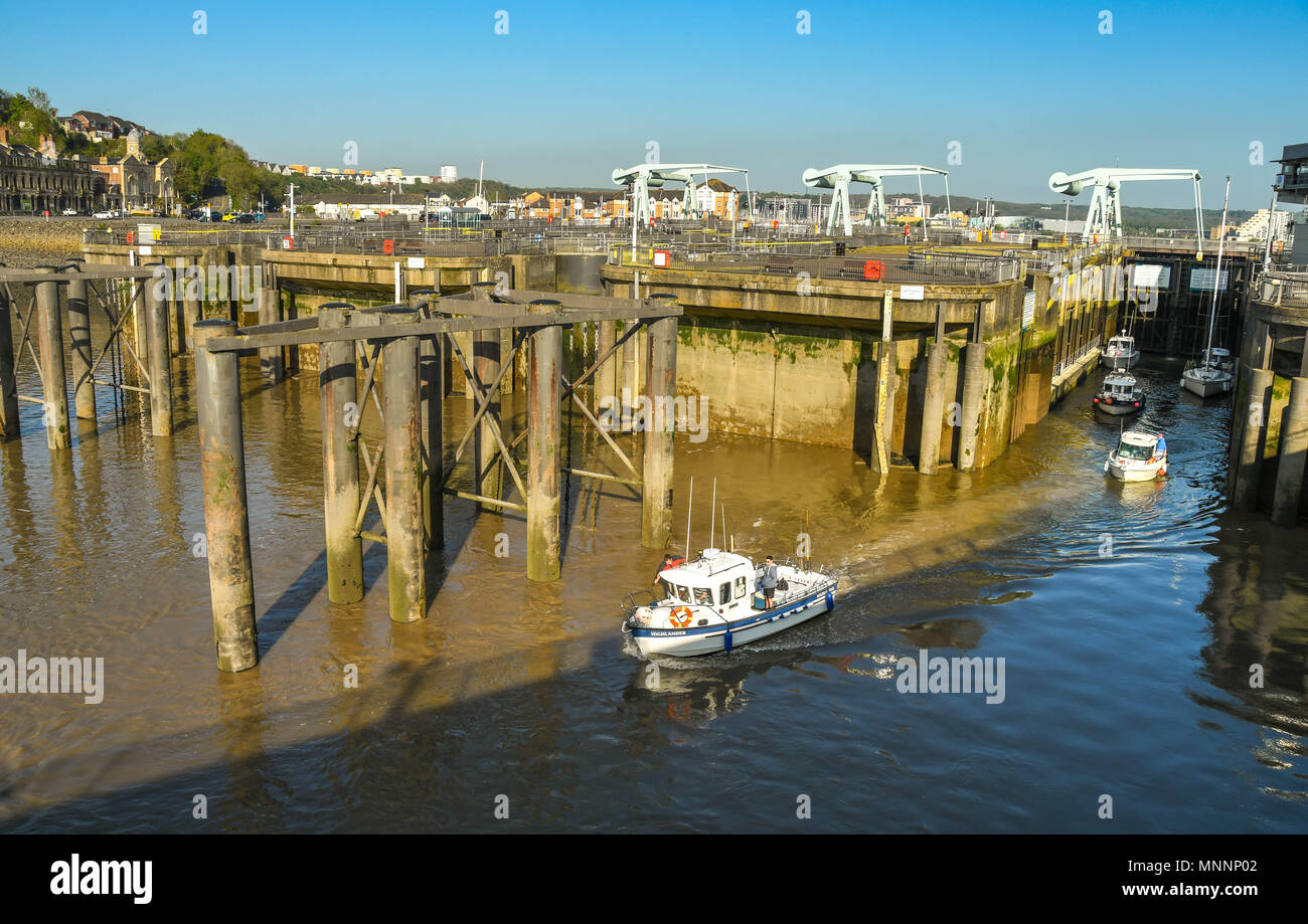 Small fishing boats leaving one of the locks in the Cardiff Bay barrage ...