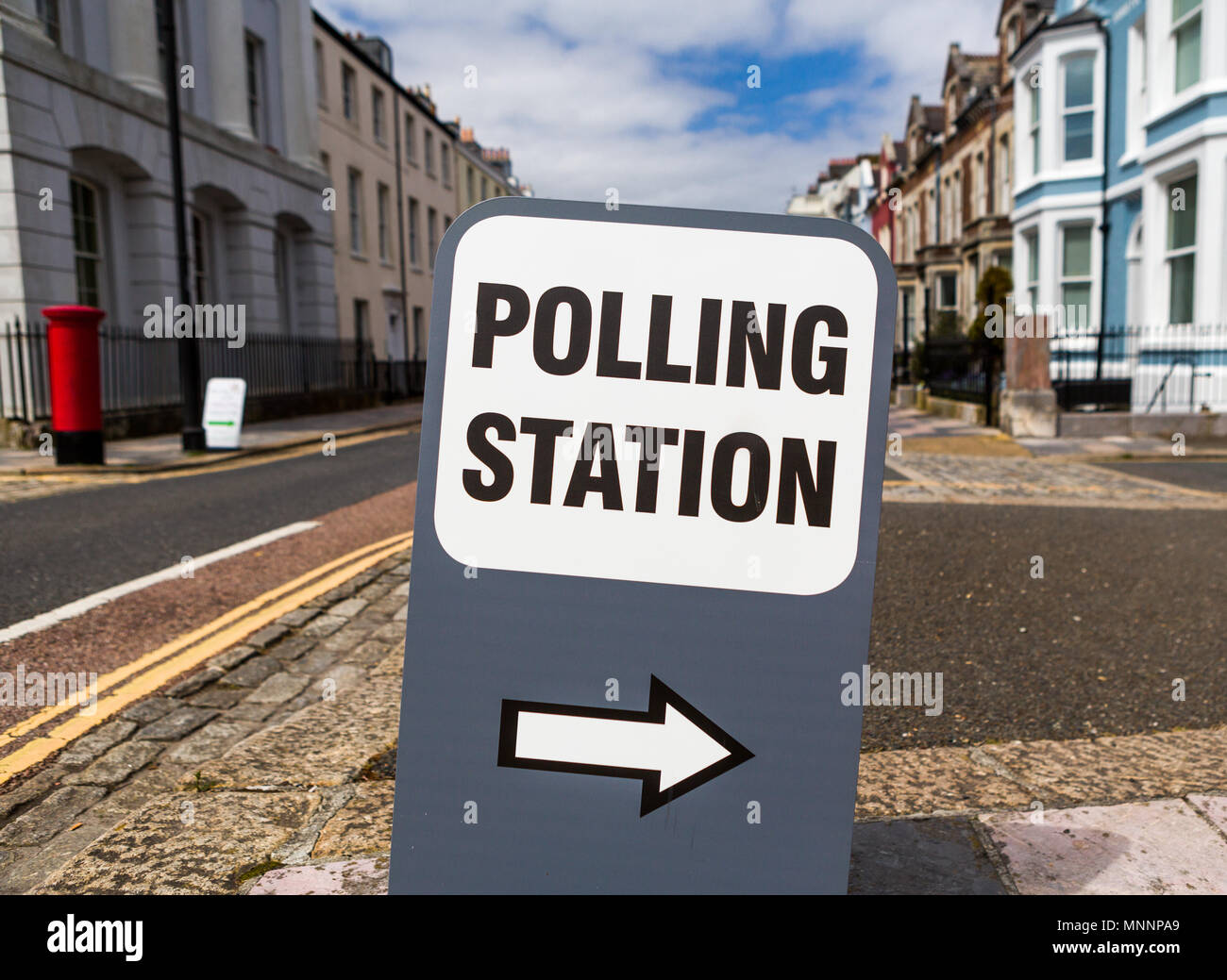 Polling Station sign with right pointing arrow on a typical British ...