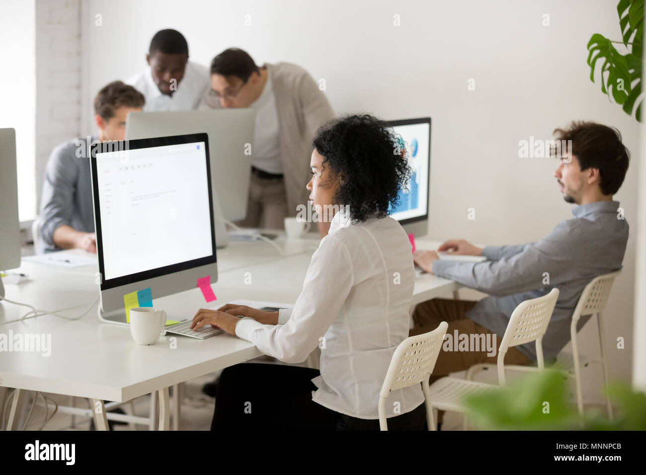 African-american woman manager focused on computer work in multi Stock ...