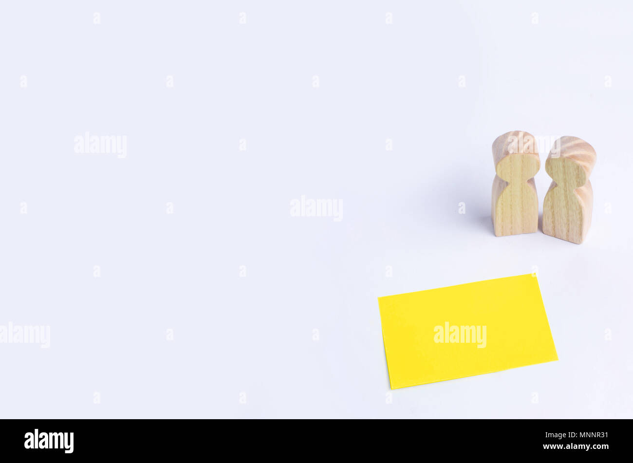 Two human figures stand near the sticker on a white background. Place ...