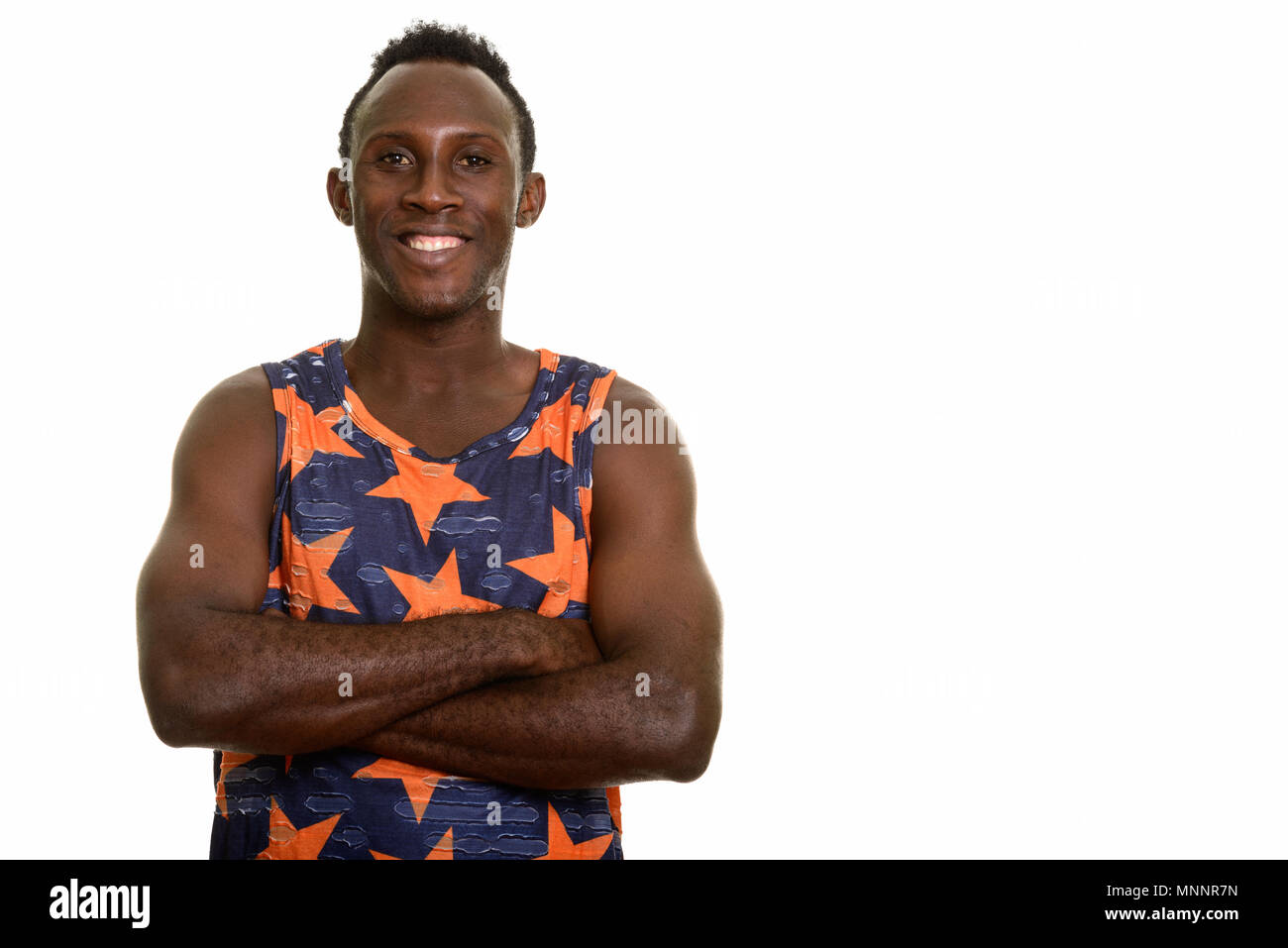 Young happy black African man smiling with arms crossed Stock Photo - Alamy
