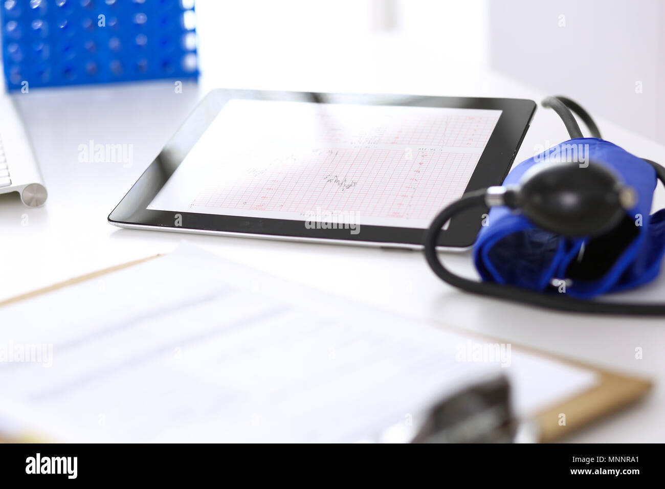 Workplace of doctor. Tablet ps showing heart diagrams closeup ...