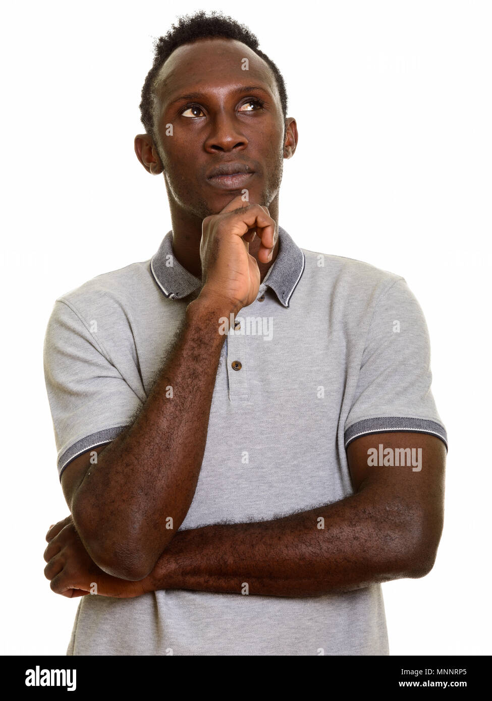 Young black African man thinking while looking up Stock Photo - Alamy