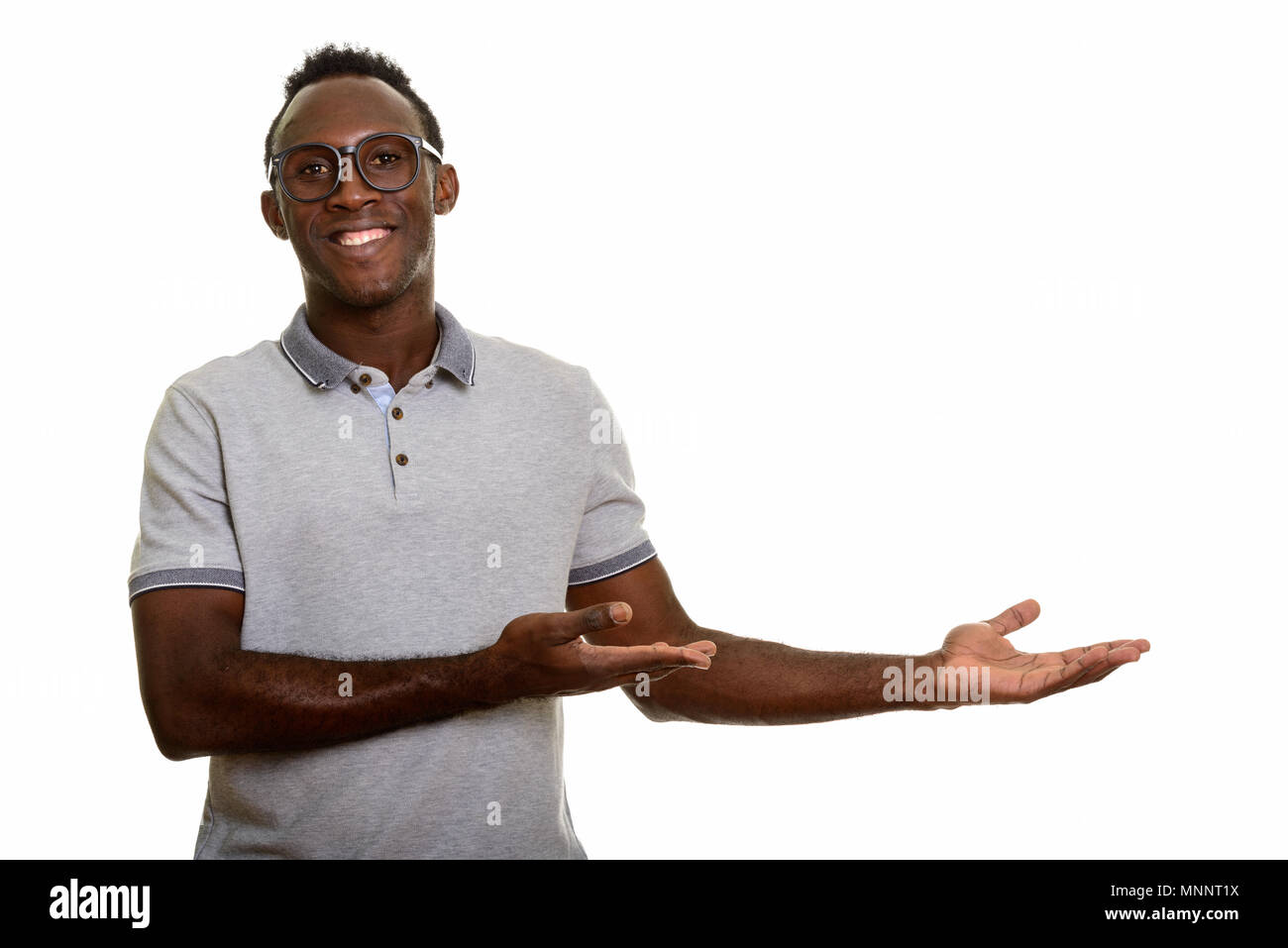Young happy African man smiling and showing something Stock Photo - Alamy