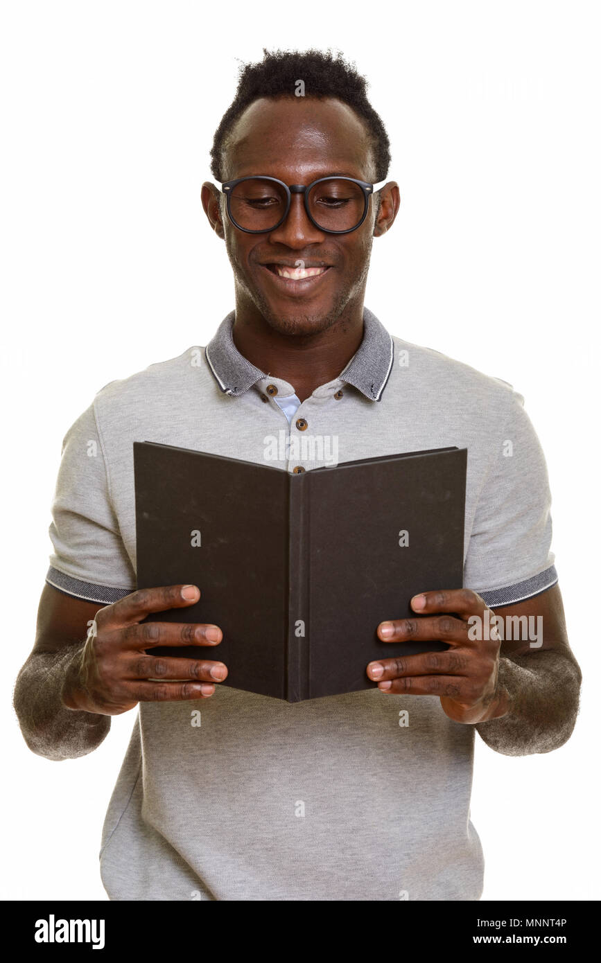 Young happy African man smiling while reading book Stock Photo - Alamy
