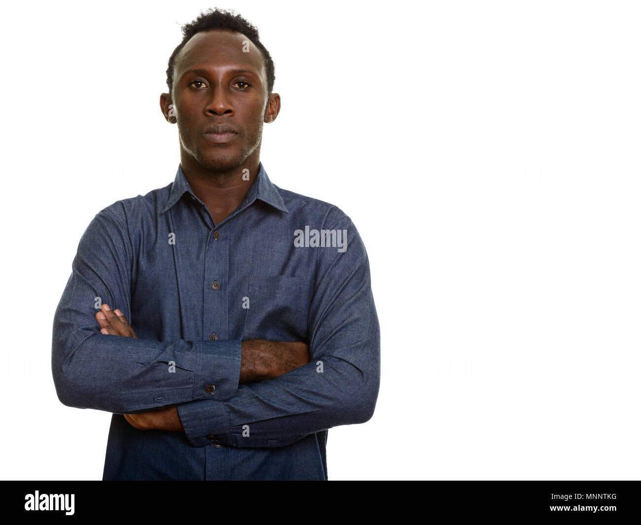 Young black African man with arms crossed Stock Photo - Alamy