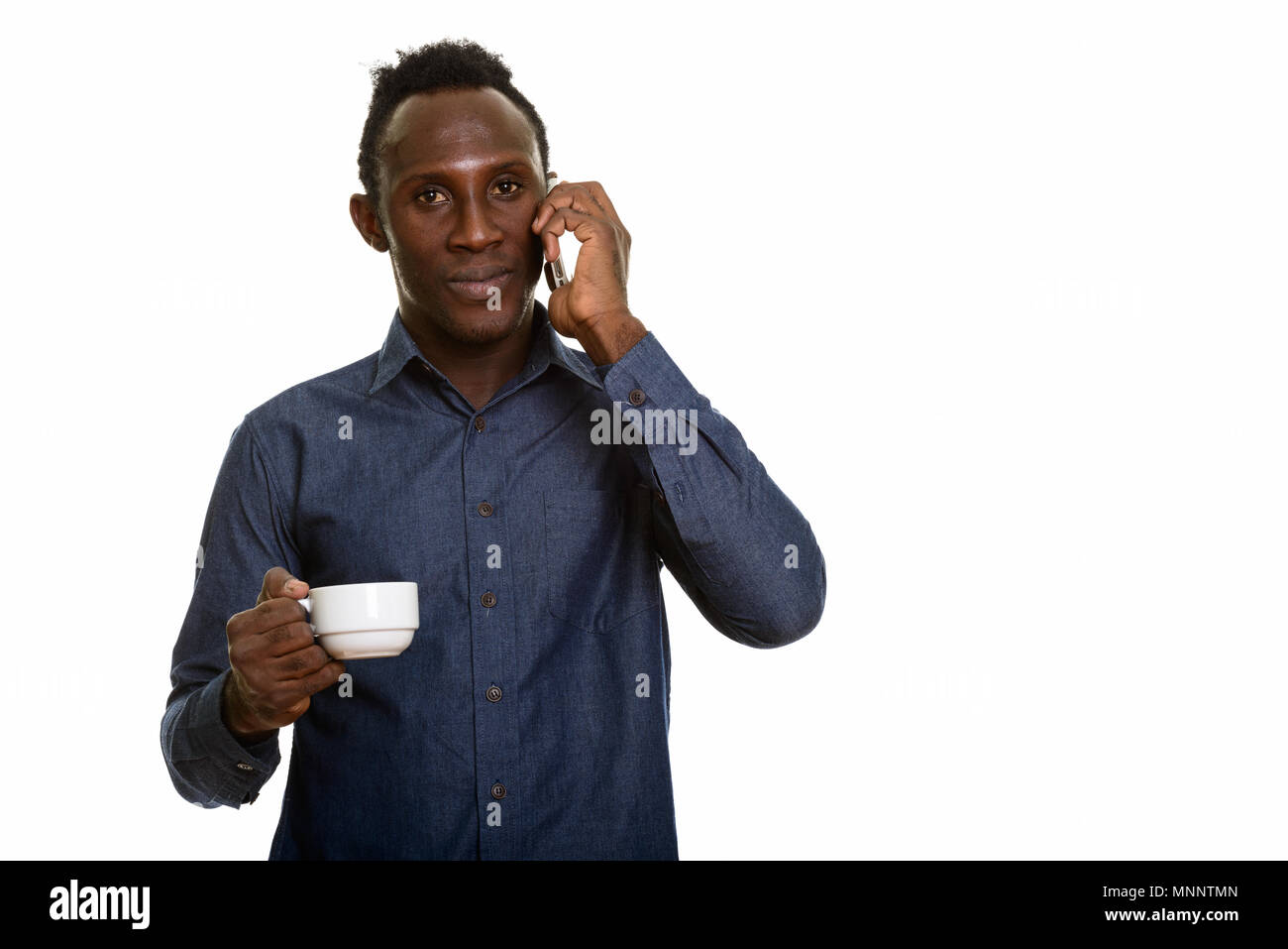 Young black African man talking on mobile phone and holding coff Stock ...