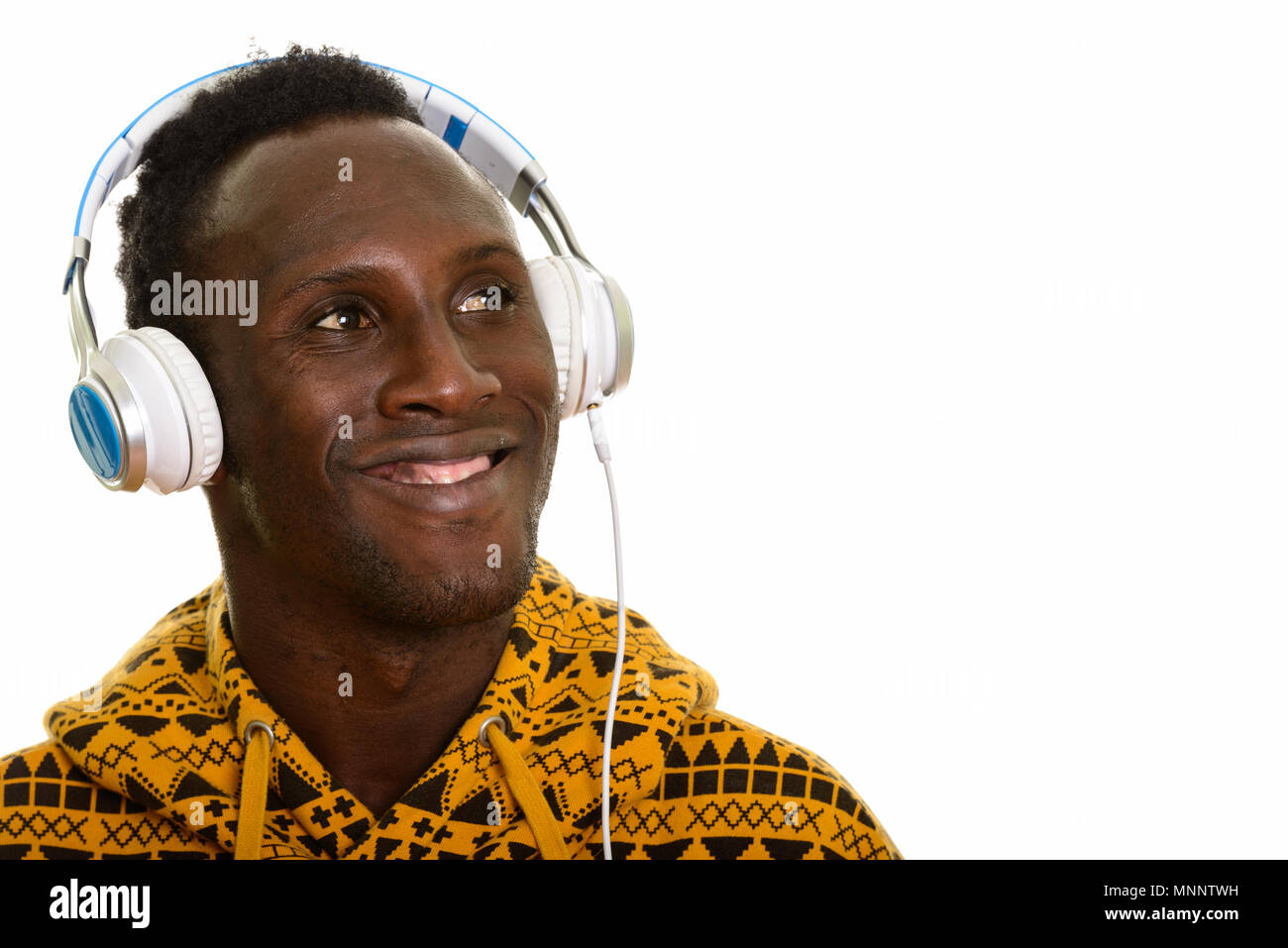 Young happy black African man smiling and listening to music whi Stock ...