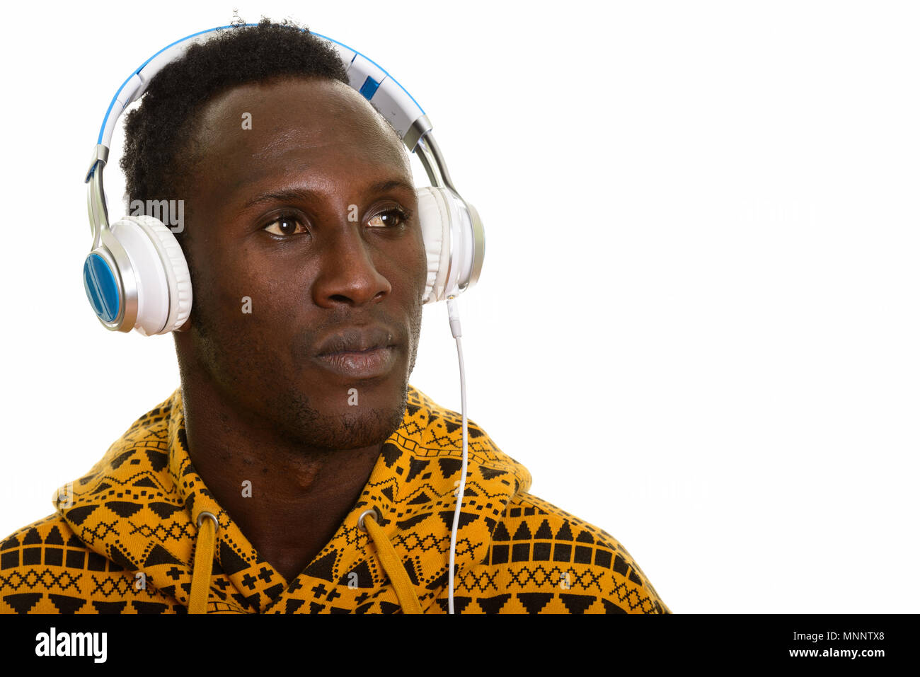 Young black African man listening to music while thinking Stock Photo ...