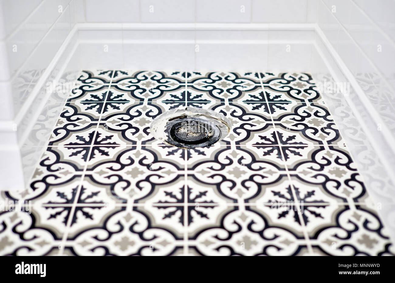 New toilet drain and tile flooring for home renovation Stock Photo - Alamy