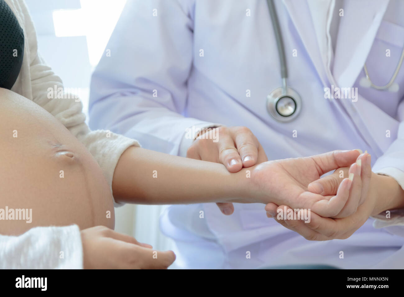 Doctor checking heart rate hi-res stock photography and images - Alamy