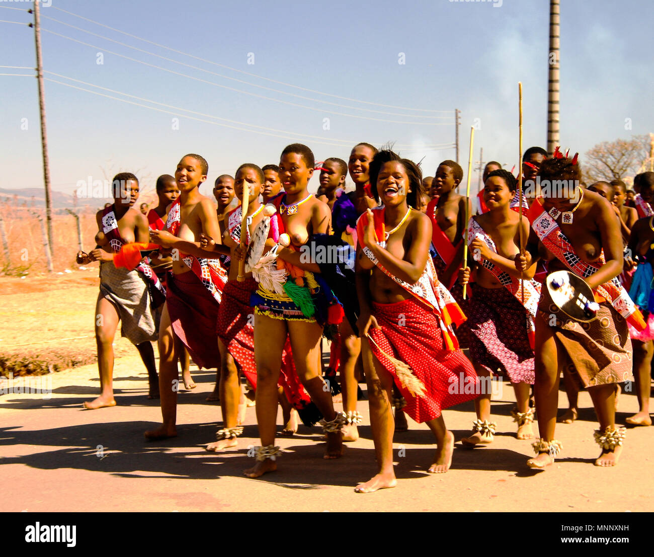 Women in traditional costumes marching at the Umhlanga aka Reed Dance ...