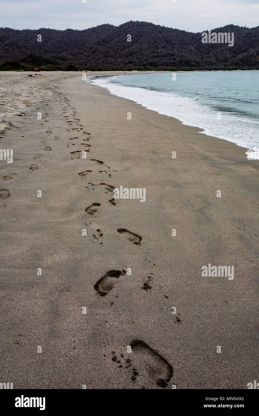 Foot steps in the sand on a beach in Ecuador Stock Photo - Alamy