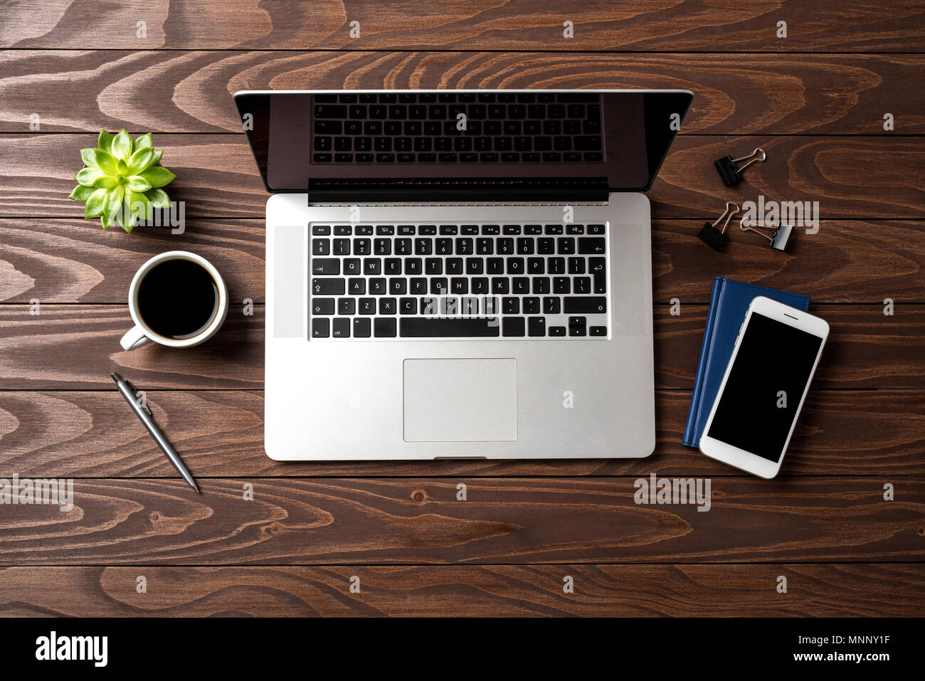 Wooden office desktop with laptop and accessories Stock Photo - Alamy