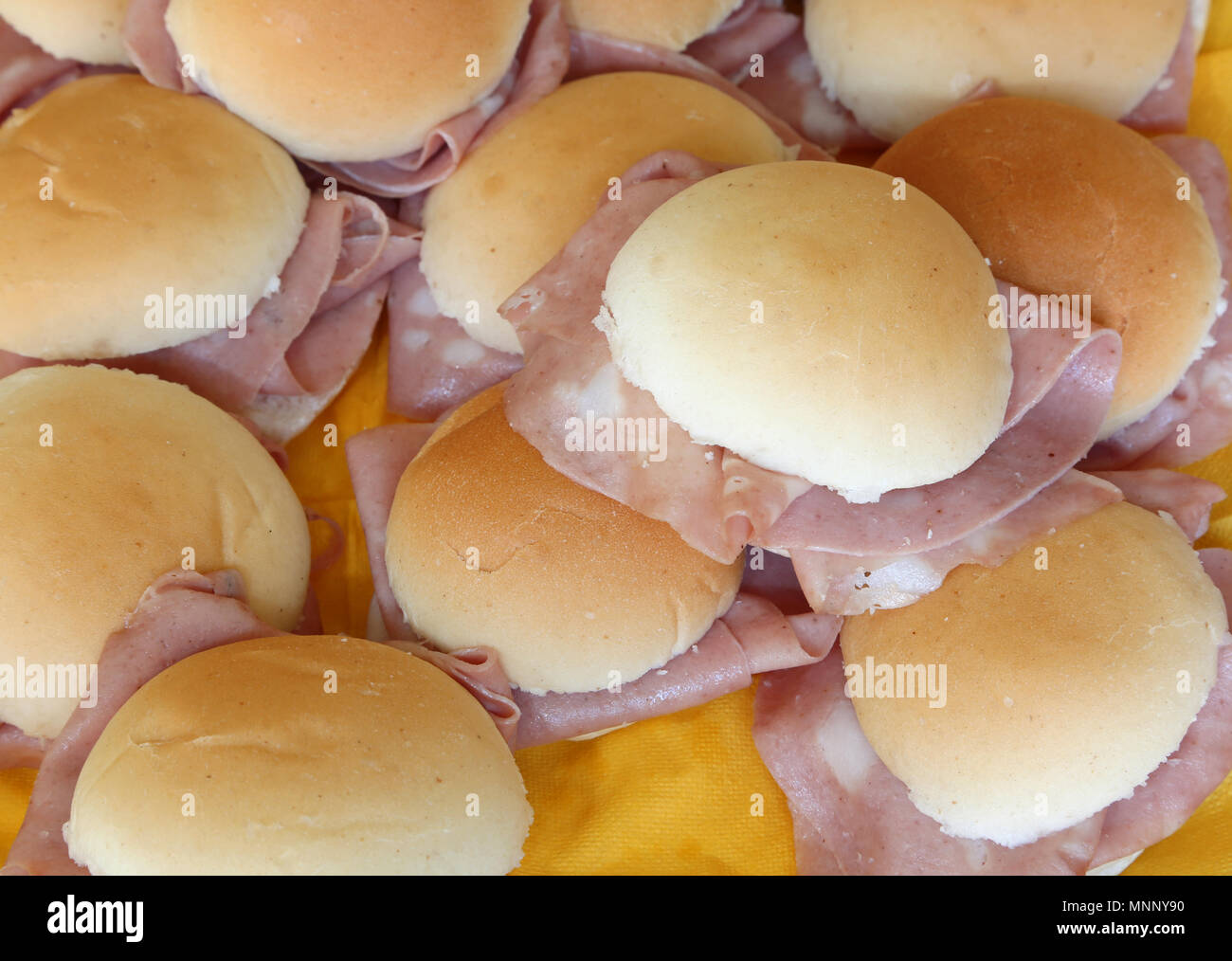 Round milk sandwiches stuffed with ham on a buffet table Stock Photo ...