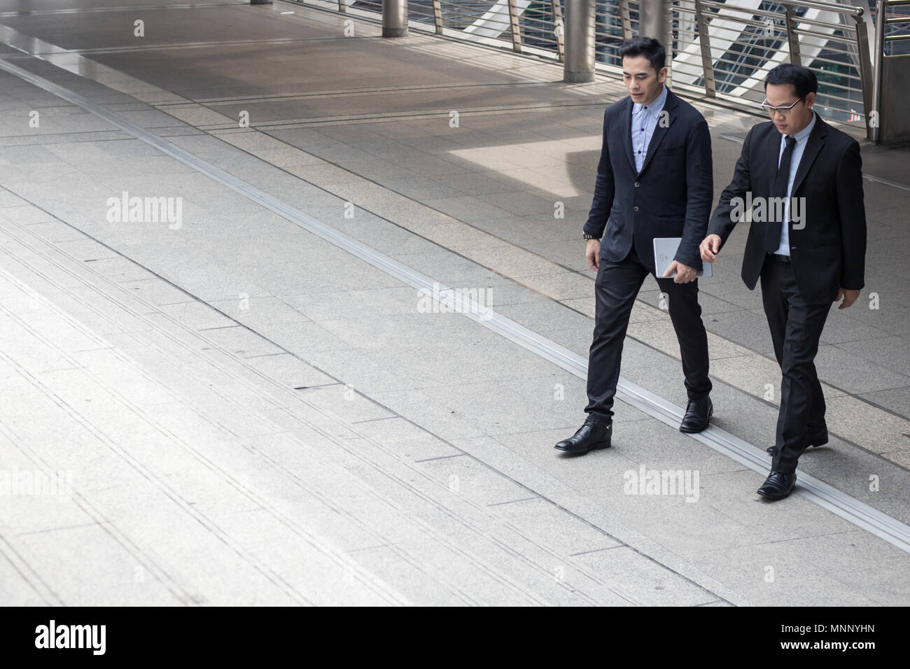 Two business people walking up stairs hi-res stock photography and ...