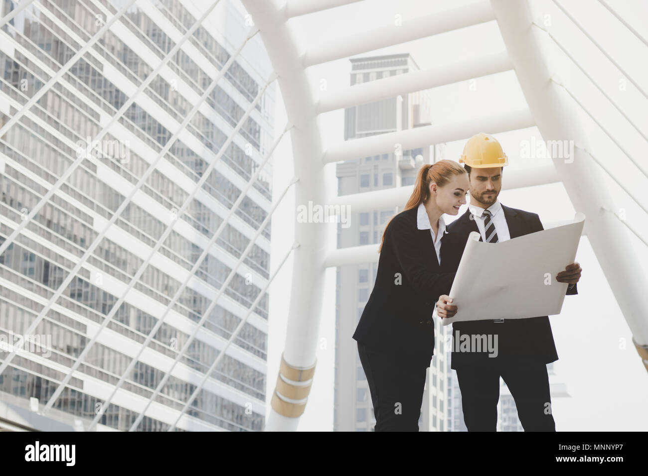 Businesswoman pointing and engineering planning at construction area on ...